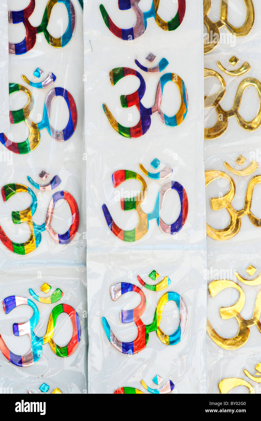 Multicoloured Om sticker badges on indian market stall. India Stock ...