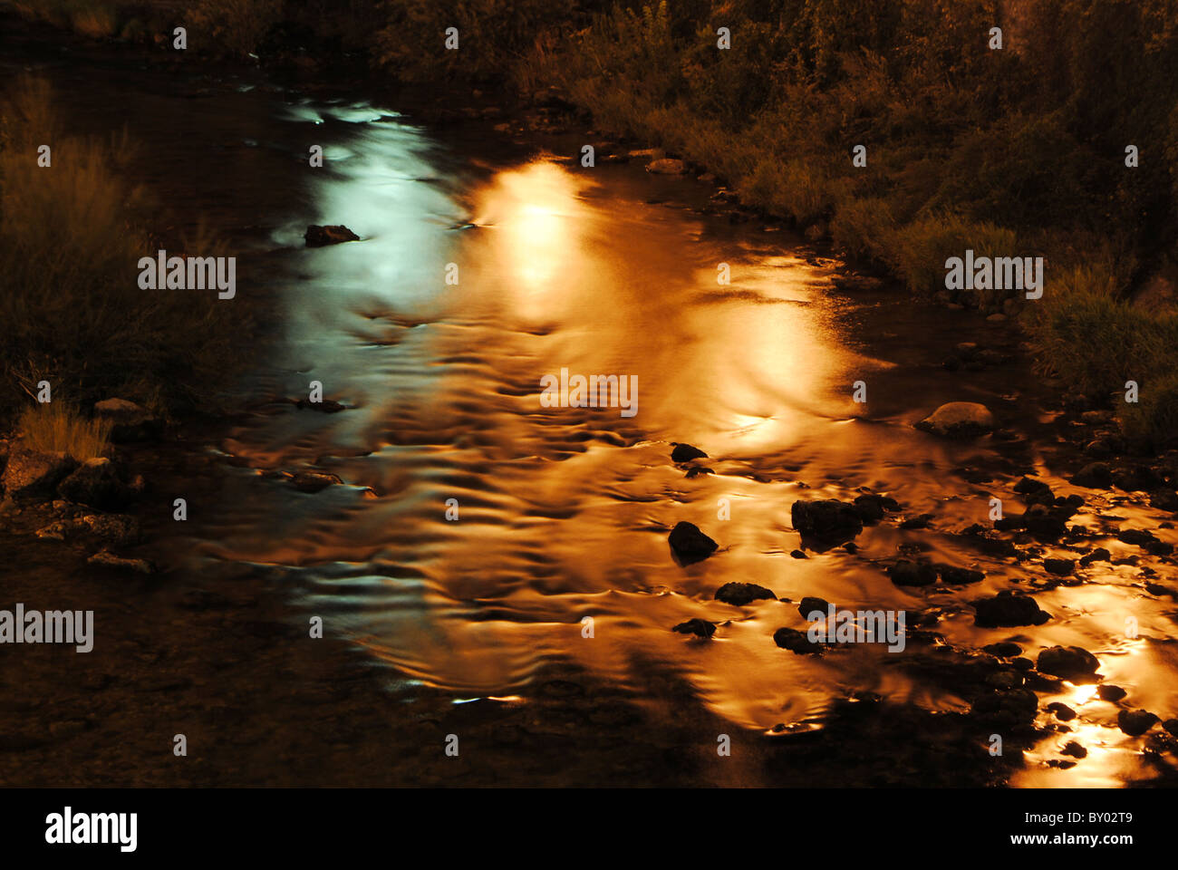 river in the night with radiant colors of yellow and green Stock Photo ...