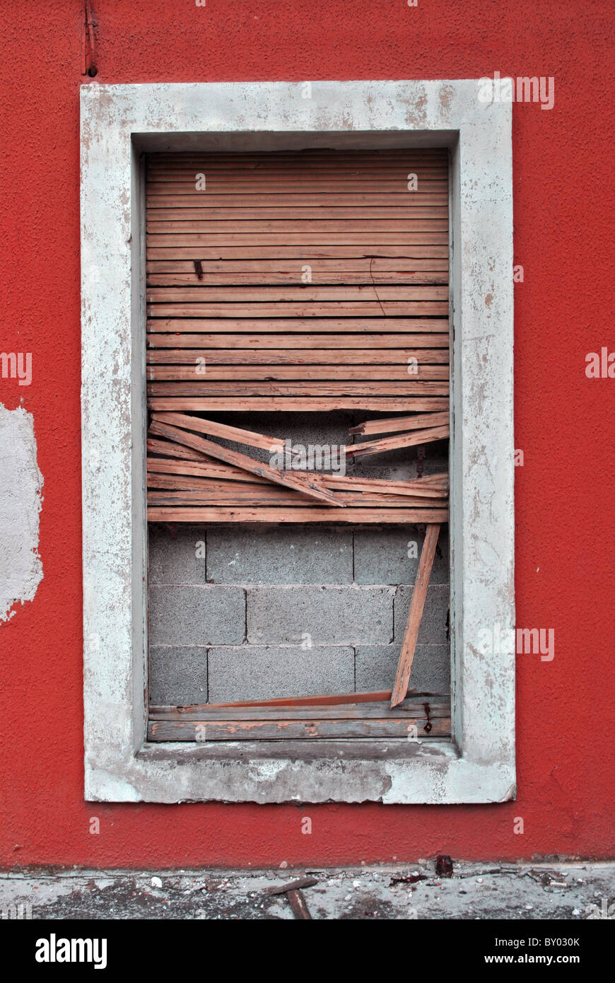 broken windows and shutters on the red wall destroyed Stock Photo - Alamy