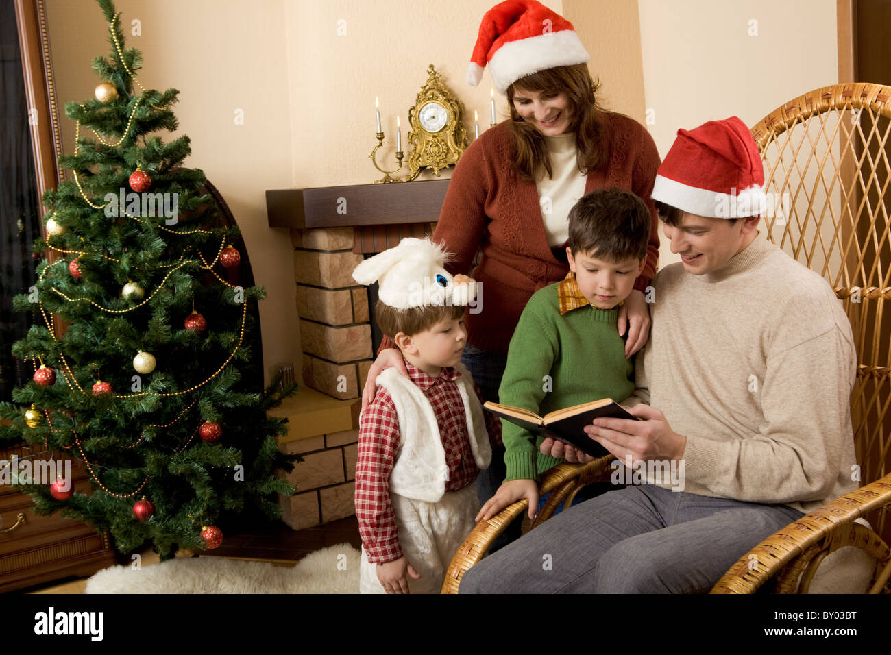 Portrait of family gathered together to read interesting fairy tale ...