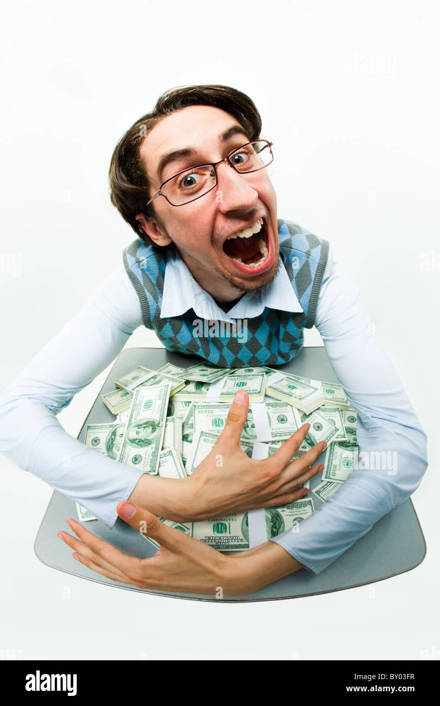 Portrait of greedy male raking in dollars and being glad Stock Photo ...