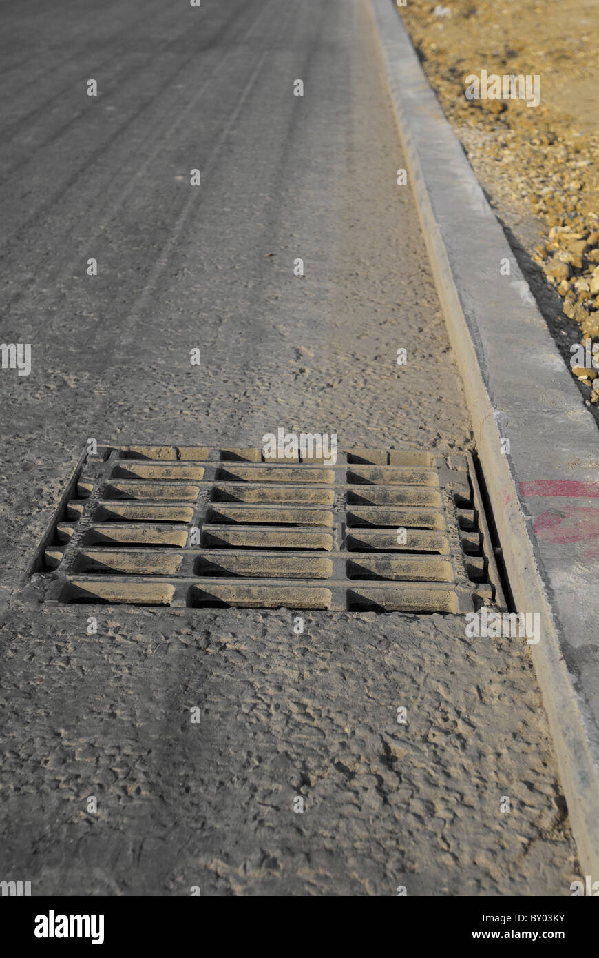 Drain in newly laid road Stock Photo - Alamy