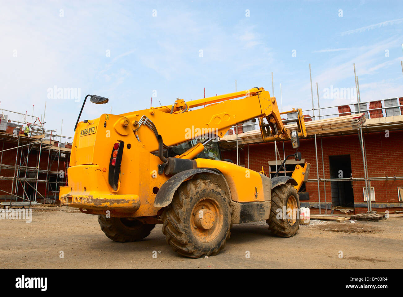 Rear view of forklift on house building site Stock Photo - Alamy