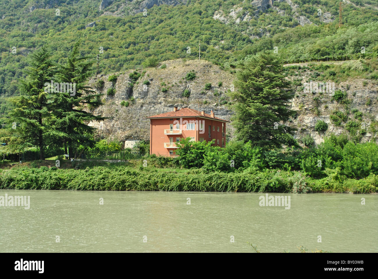cottage with a river surrounded by nature Stock Photo - Alamy
