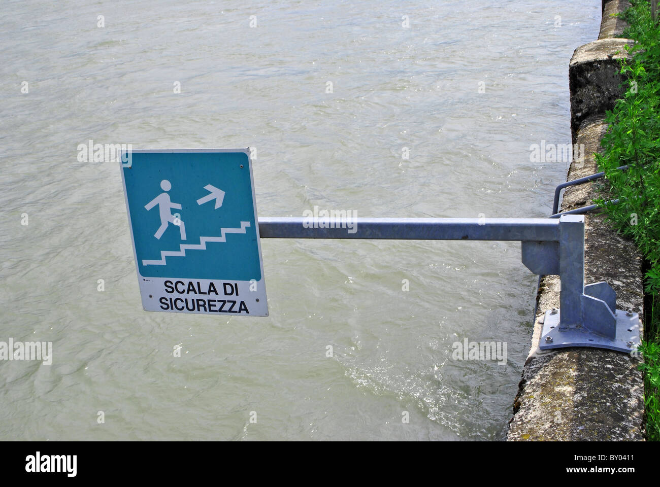indicating an emergency exit in the water channel Stock Photo - Alamy