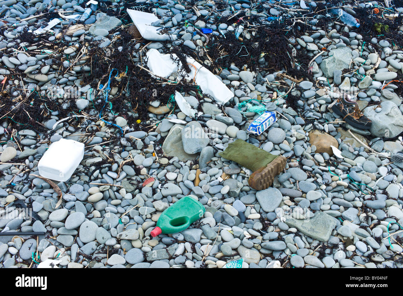 Plastic detritis and debris litter the rocks on a beach, County Clare ...