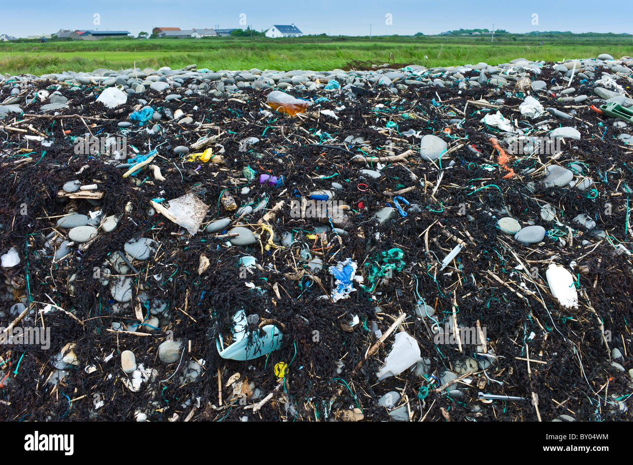 Plastic detritis and debris litter the rocks on a beach, County Clare ...