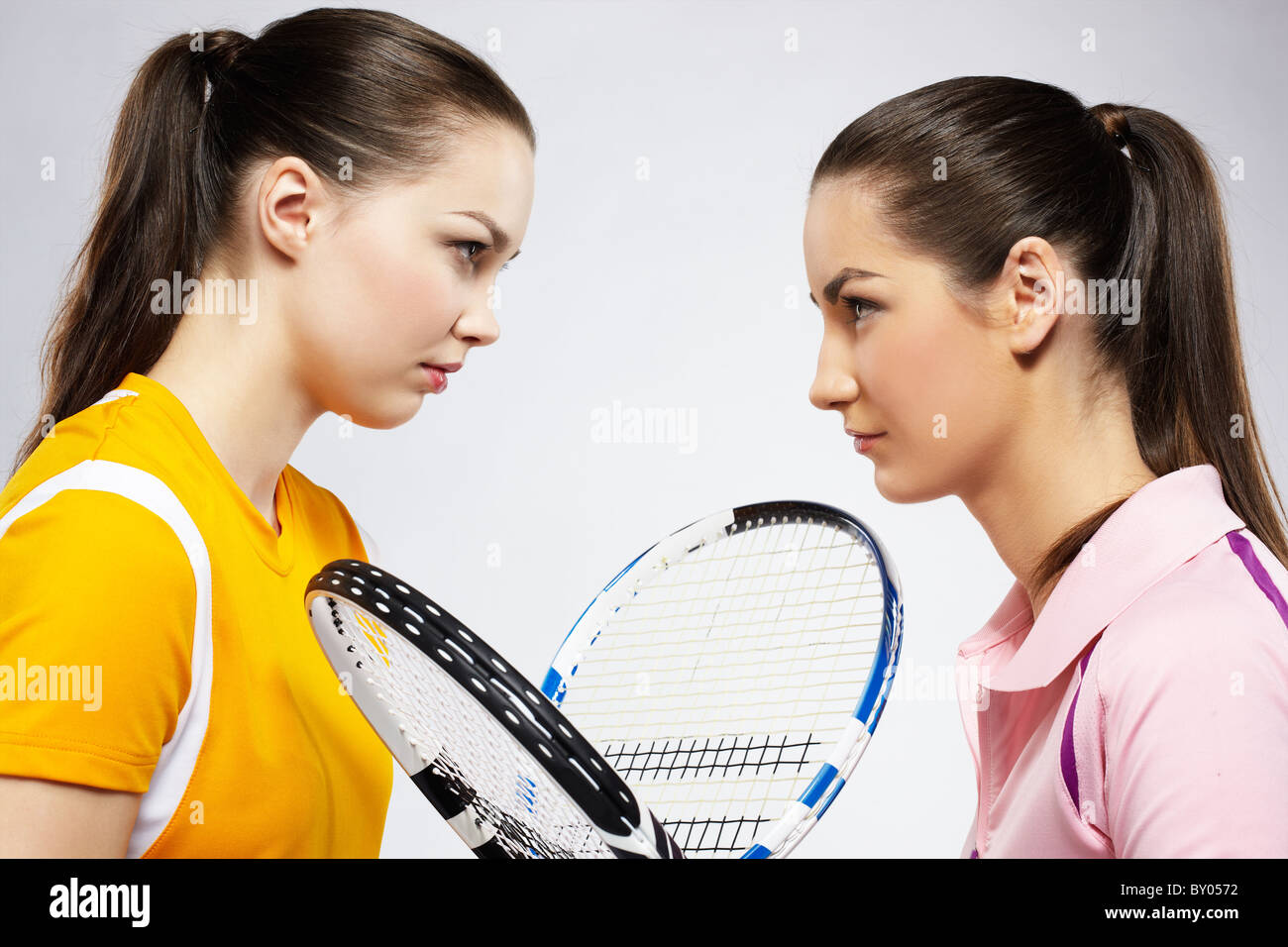 Young girls holding tennis rackets hi-res stock photography and images ...