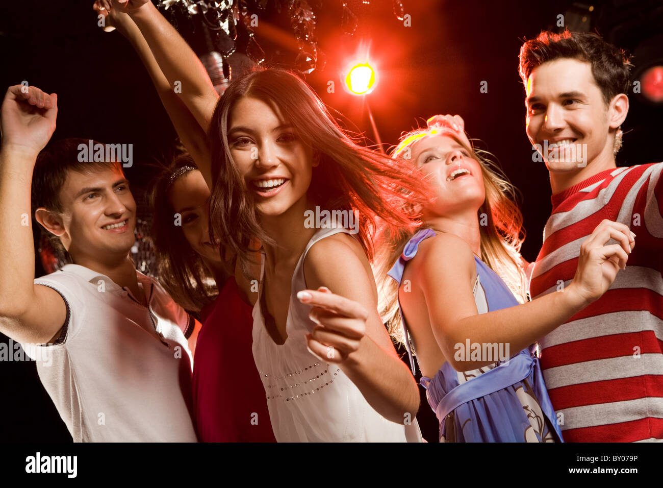 Beautiful girl making gesture meaning to join her dancing friends at ...