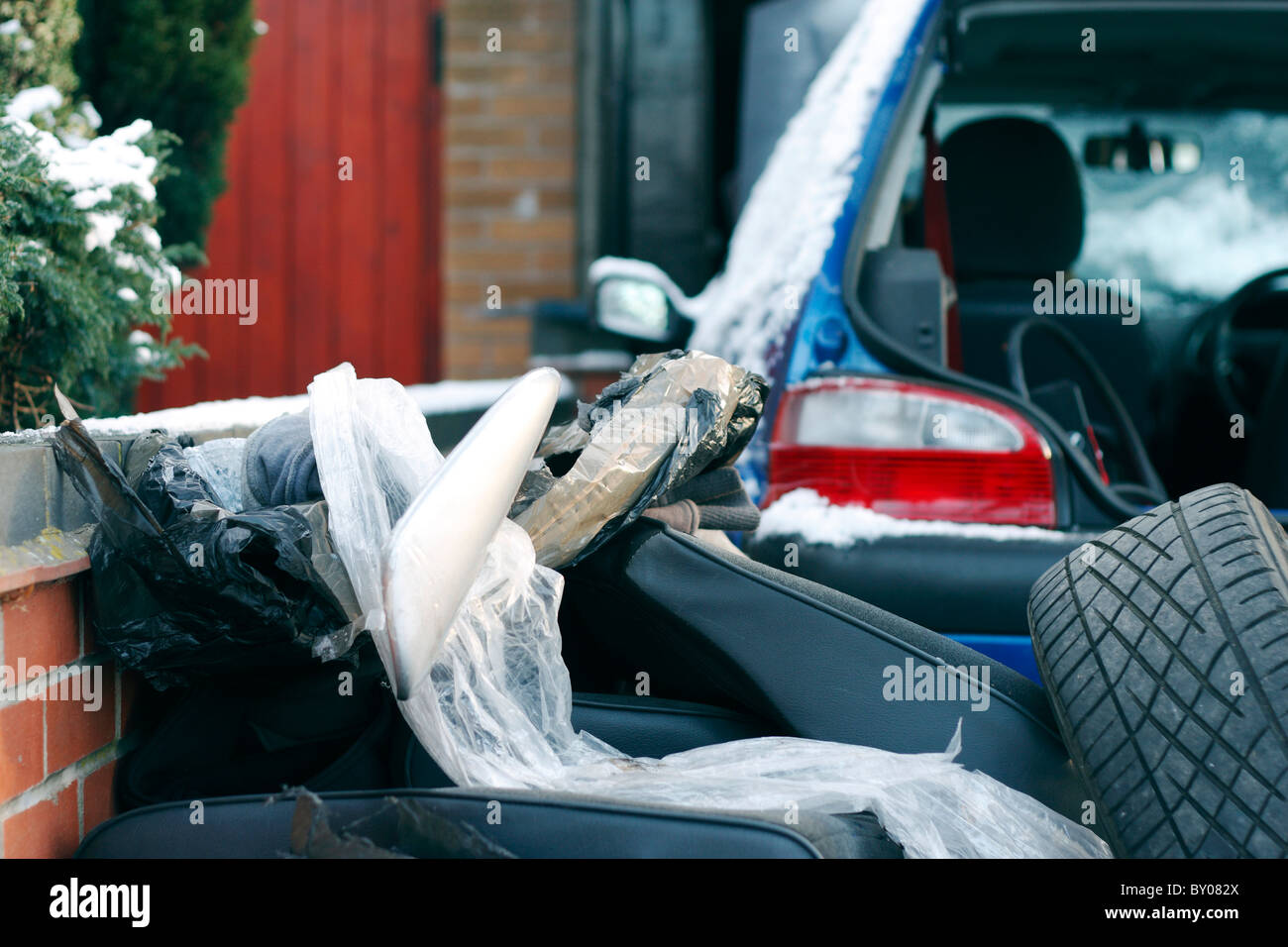 A car being emptied out on a driveway to have some work carried out on ...