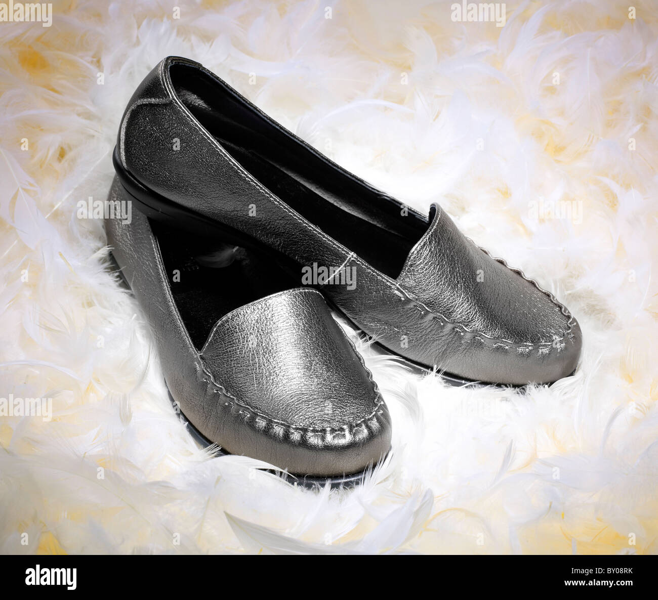 A still life shot of a pair of silver comfortable slip-on womens shoes ...