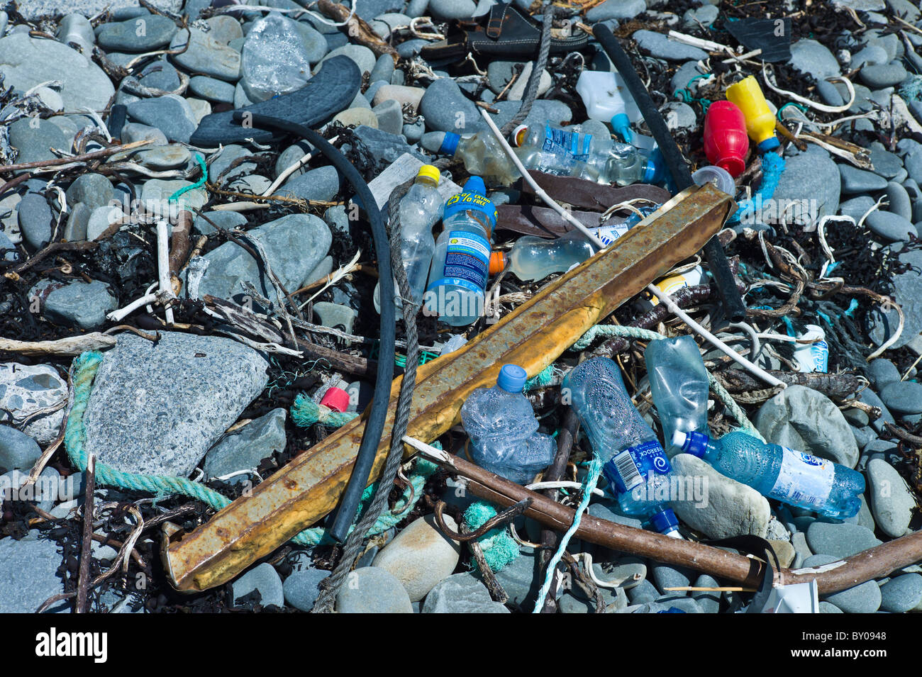 Plastic detritis and debris litter the rocks on a beach, County Clare ...