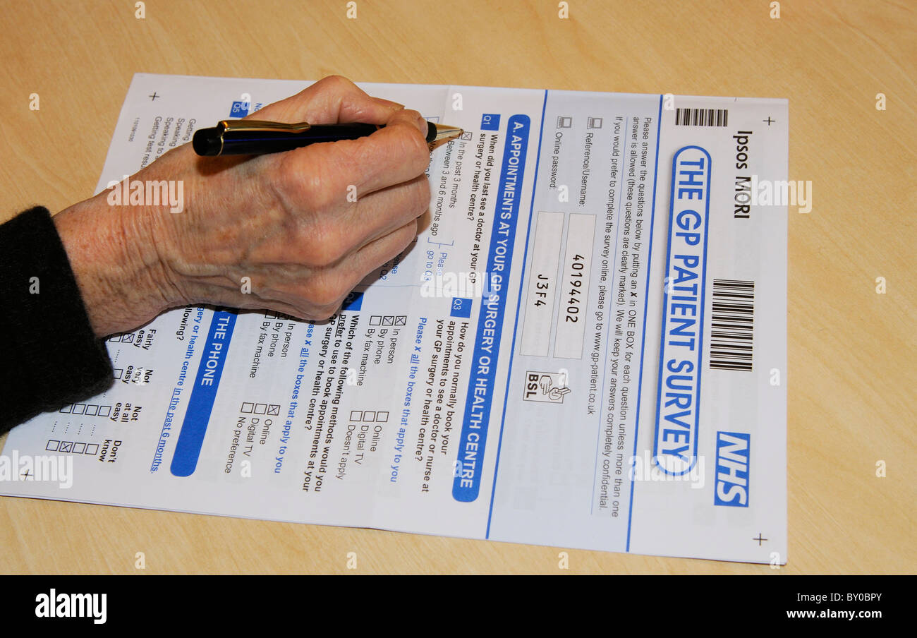 NHS GP patient survey document woman completing the questionnaire Stock ...