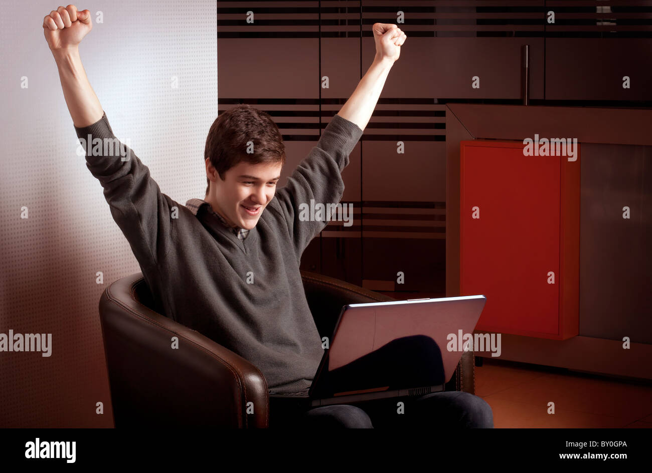 Young man raising his hands in victory Stock Photo - Alamy