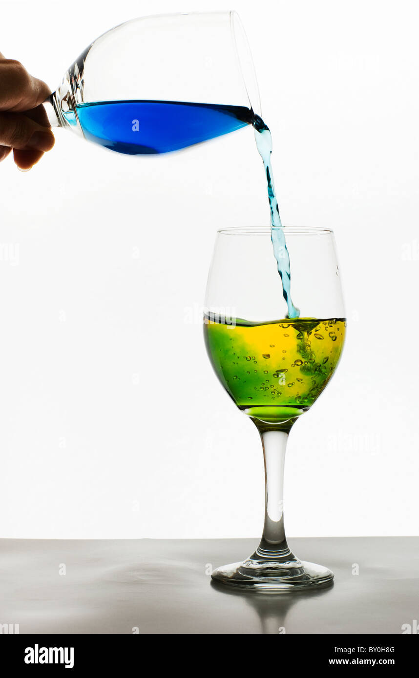 Mixing colored water in wineglasses hi-res stock photography and images ...