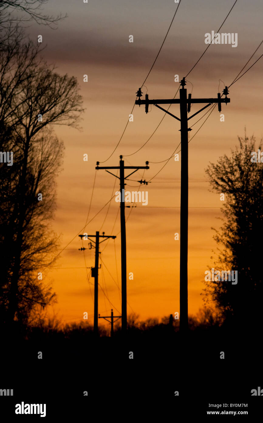 silhouette rural powerline with sunset sky Stock Photo - Alamy