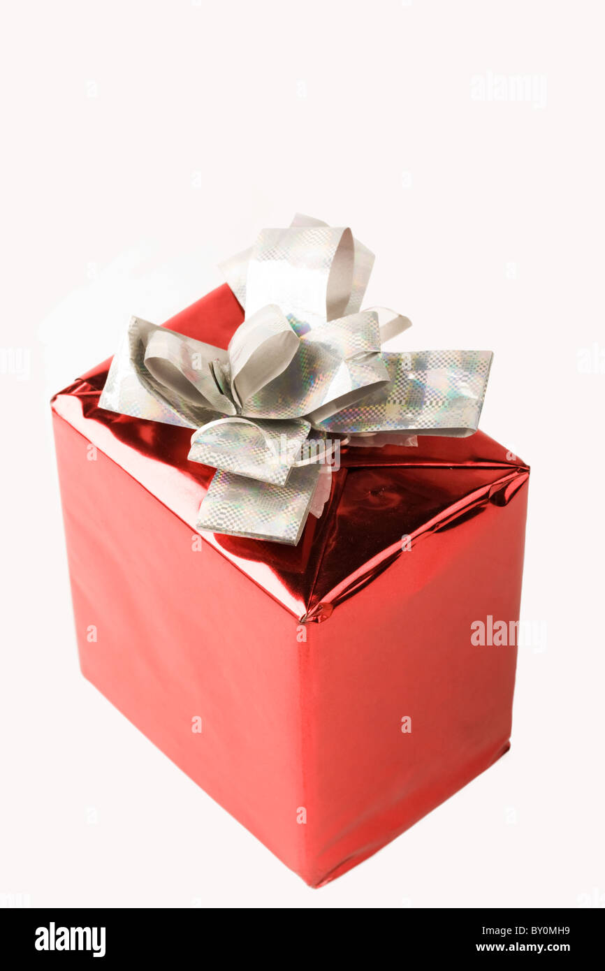 Red wrapped gift with silver knot on top isolated over white background ...