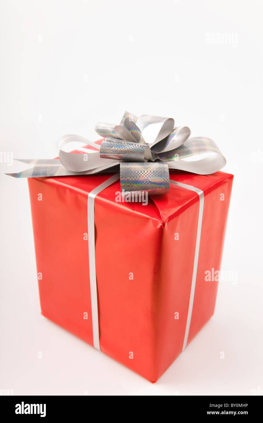 Close-up of isolated present in nice red box over white background ...
