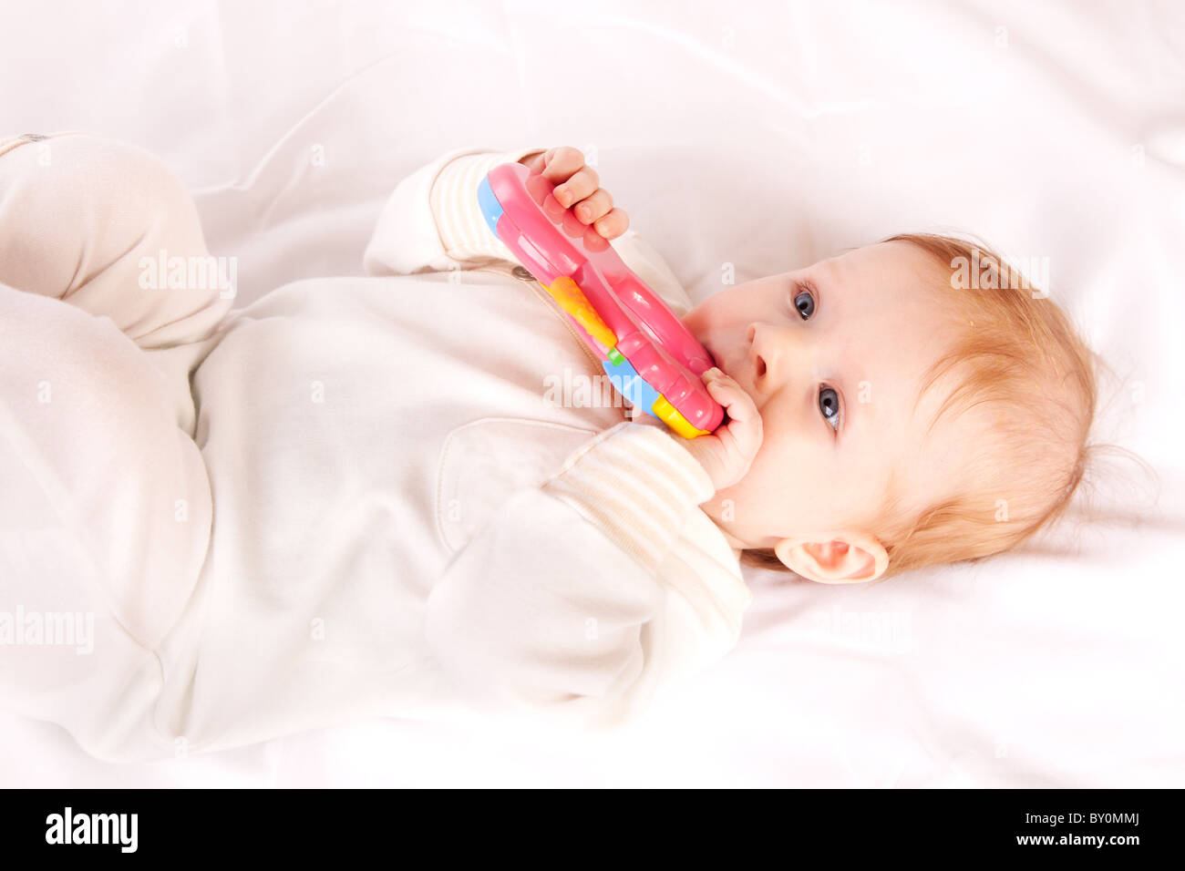 Baby playing with rubber toy Stock Photo - Alamy