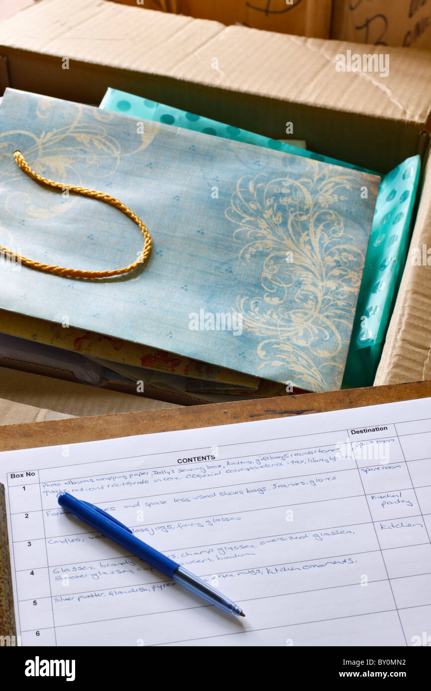 Cardboard boxes being packed for a move Stock Photo - Alamy