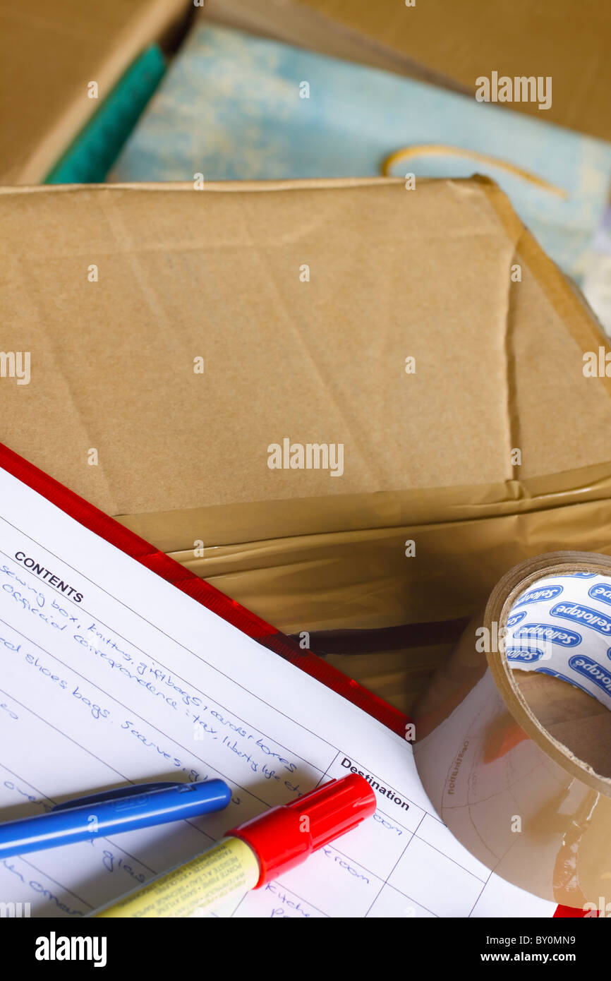 Cardboard boxes being packed for a move Stock Photo - Alamy