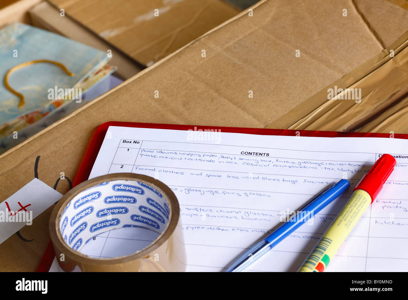 Cardboard boxes being packed for a move Stock Photo - Alamy