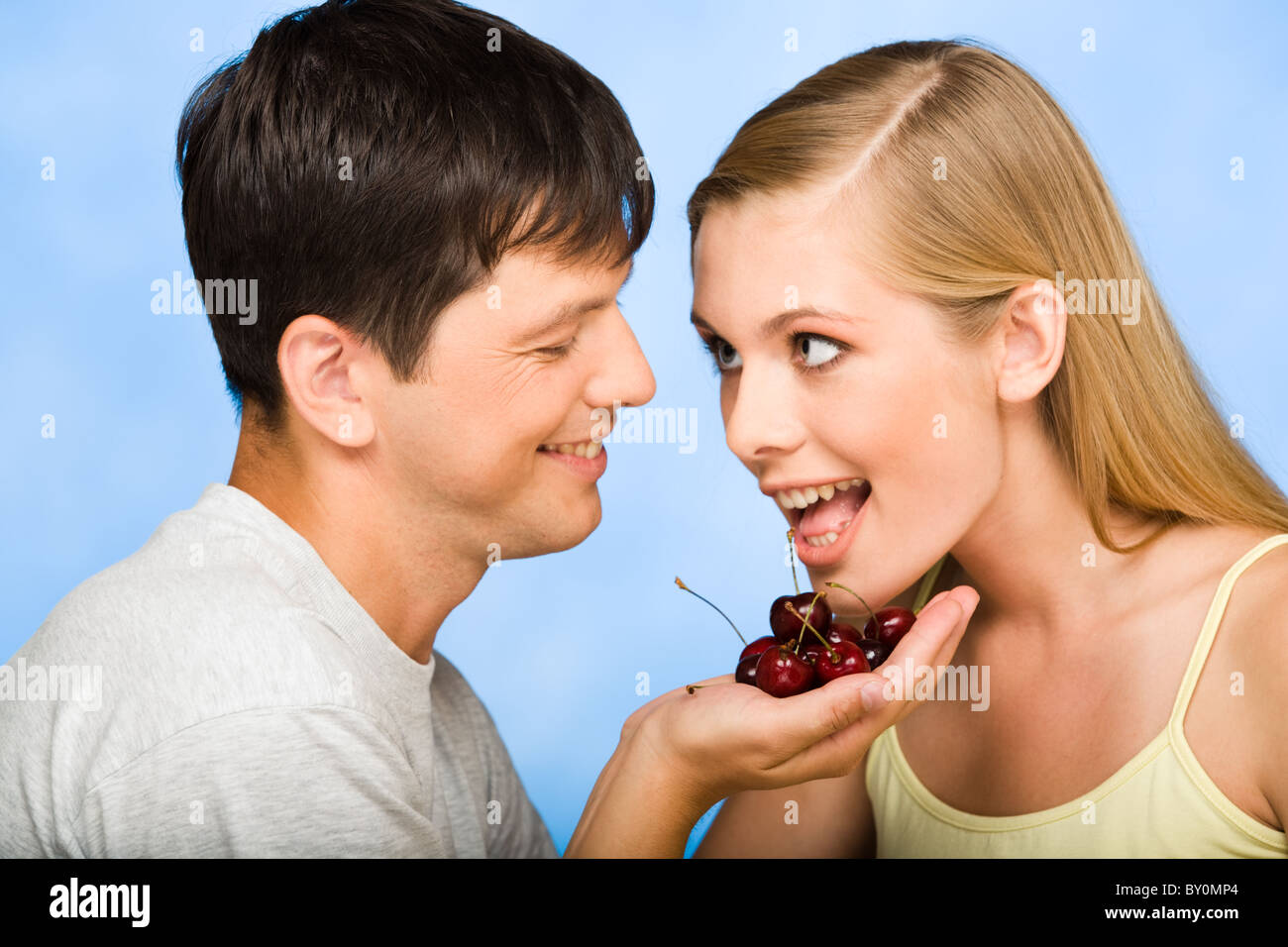 Portrait of attractive couple having a fun on a blue background Stock ...