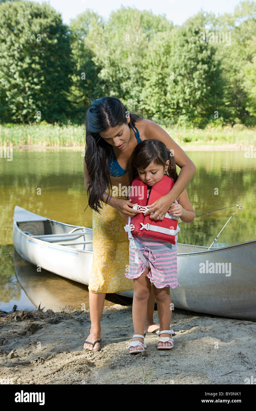 Child putting on life jacket hi-res stock photography and images - Alamy