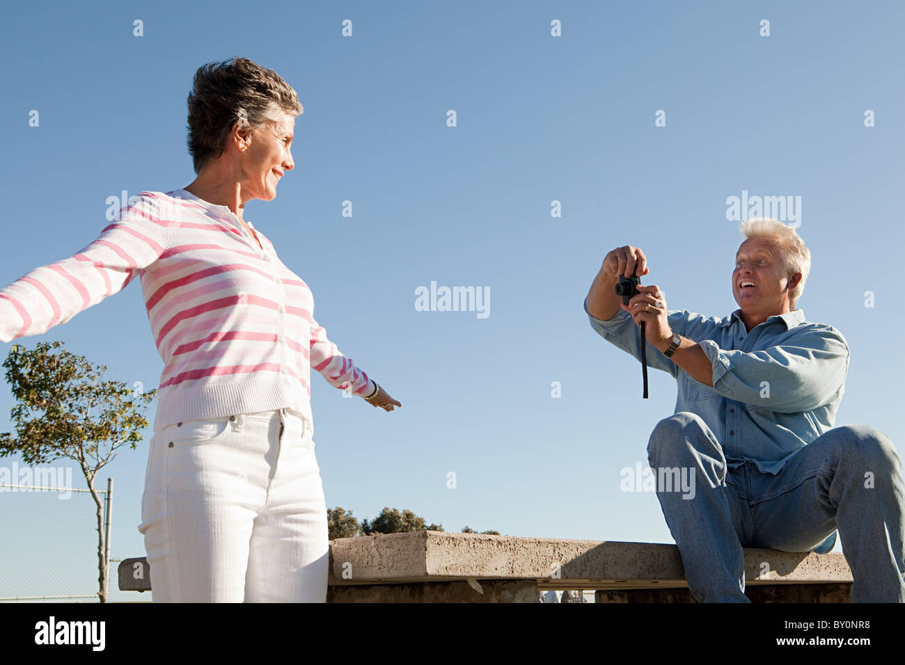 Man photographing woman Stock Photo - Alamy