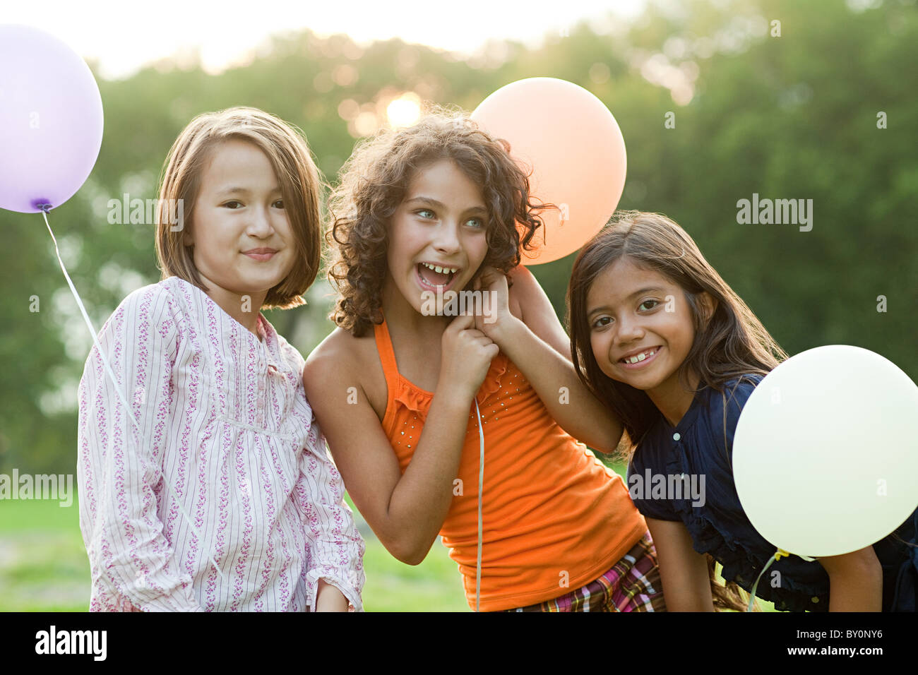Girls at birthday party holding balloons Stock Photo - Alamy