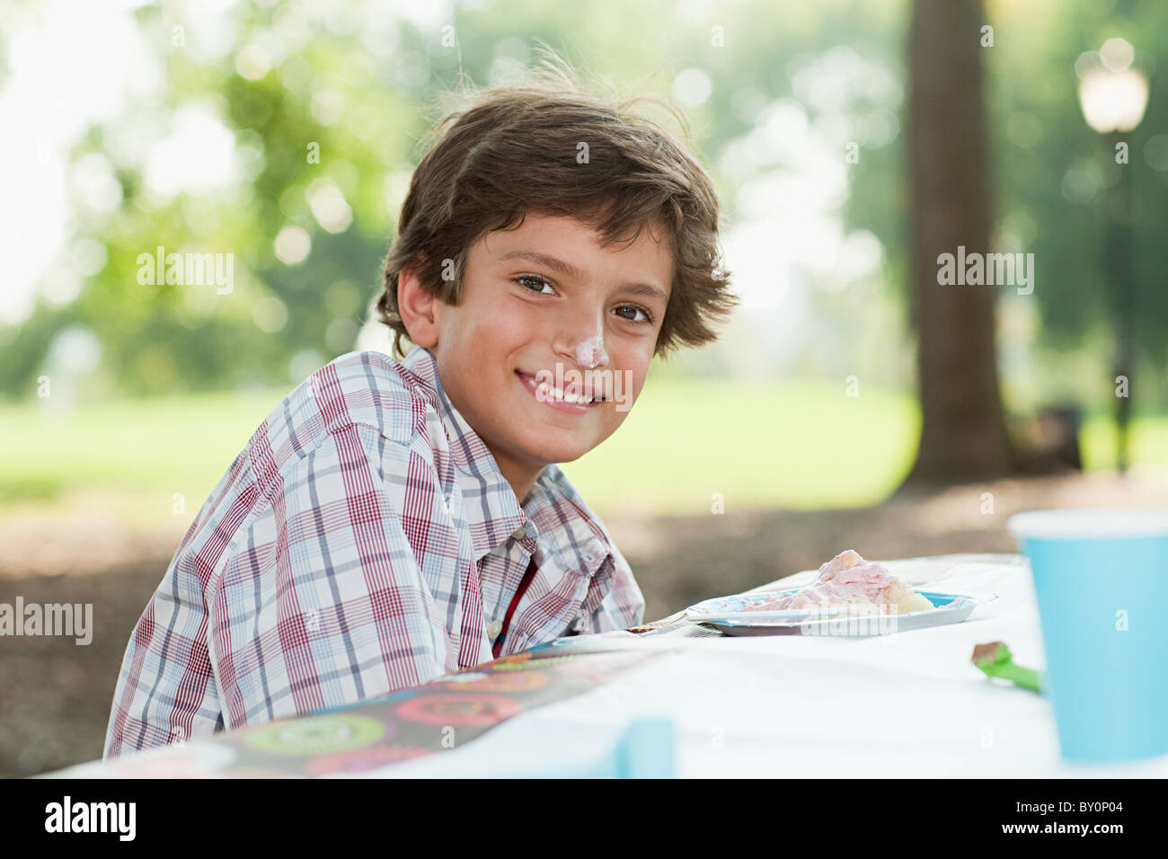 Boy at birthday party with birthday cake on his nose Stock Photo - Alamy