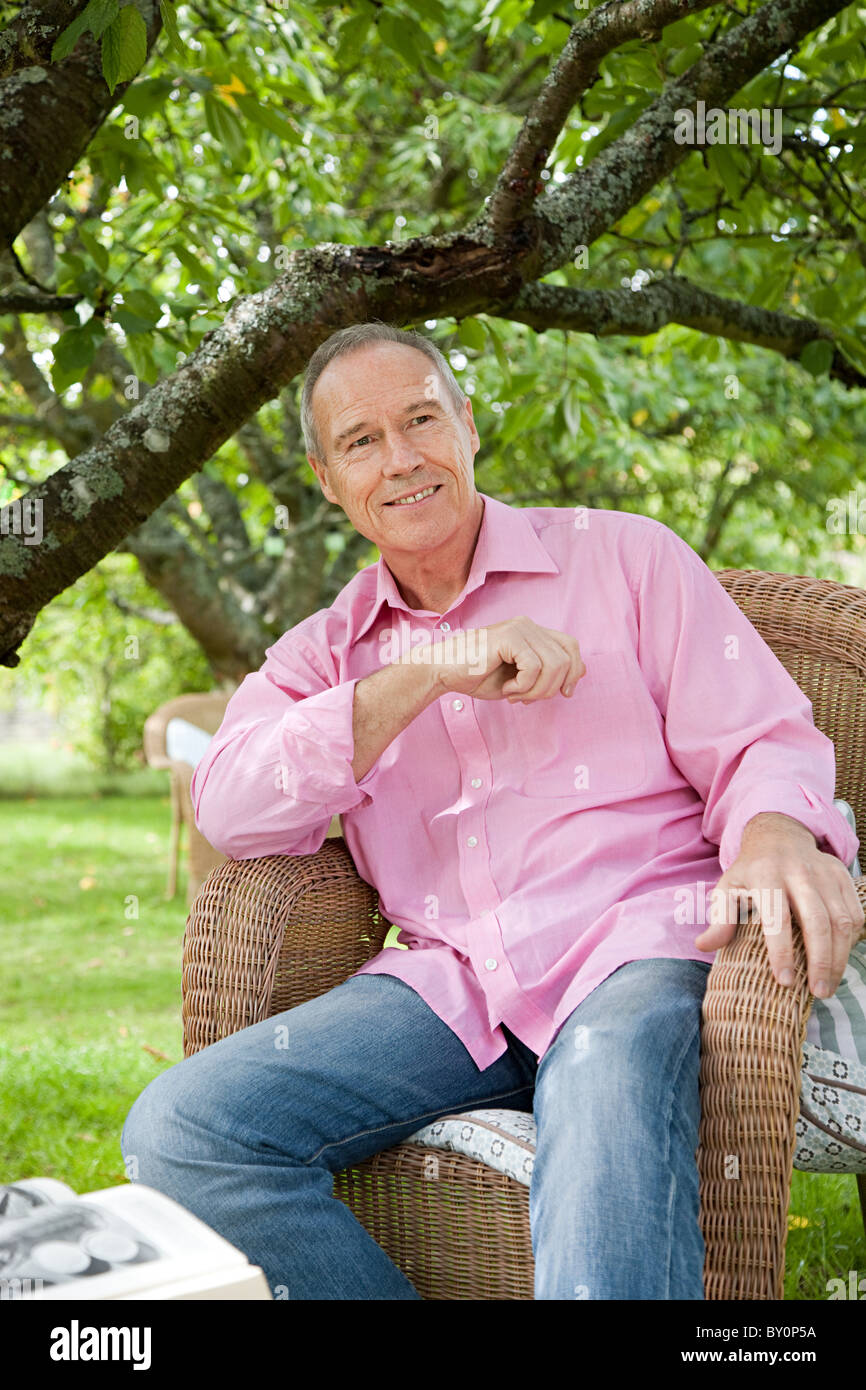 Senior man sitting on chair Stock Photo - Alamy
