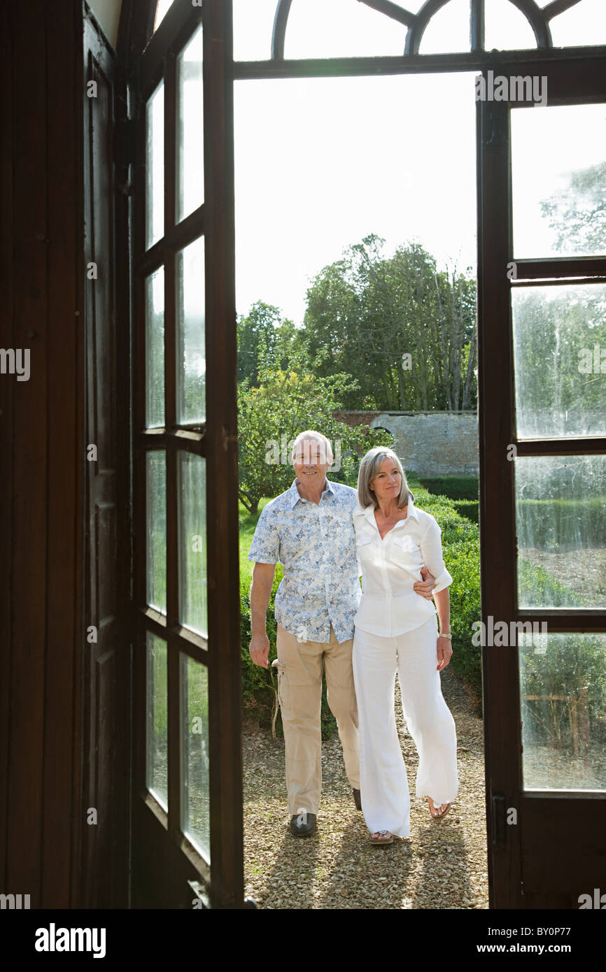Mature couple by french doors Stock Photo - Alamy
