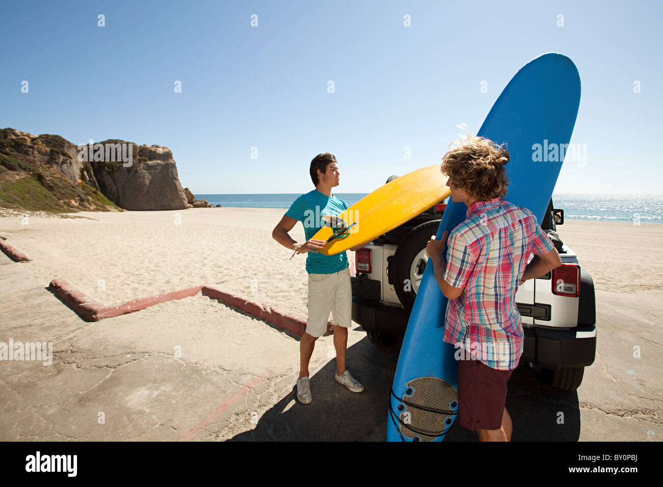 Surfers arriving at the beach Stock Photo - Alamy
