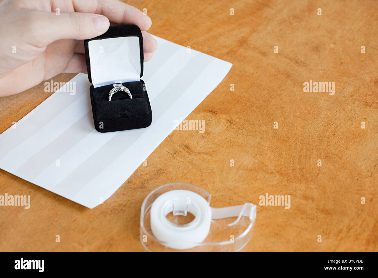 Person wrapping engagement ring Stock Photo - Alamy
