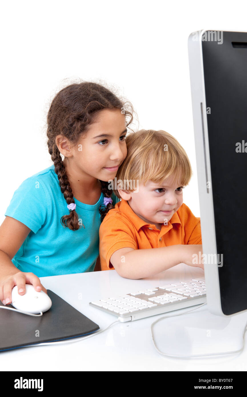 young boy and girl with a desktop computer isolated on white Stock ...