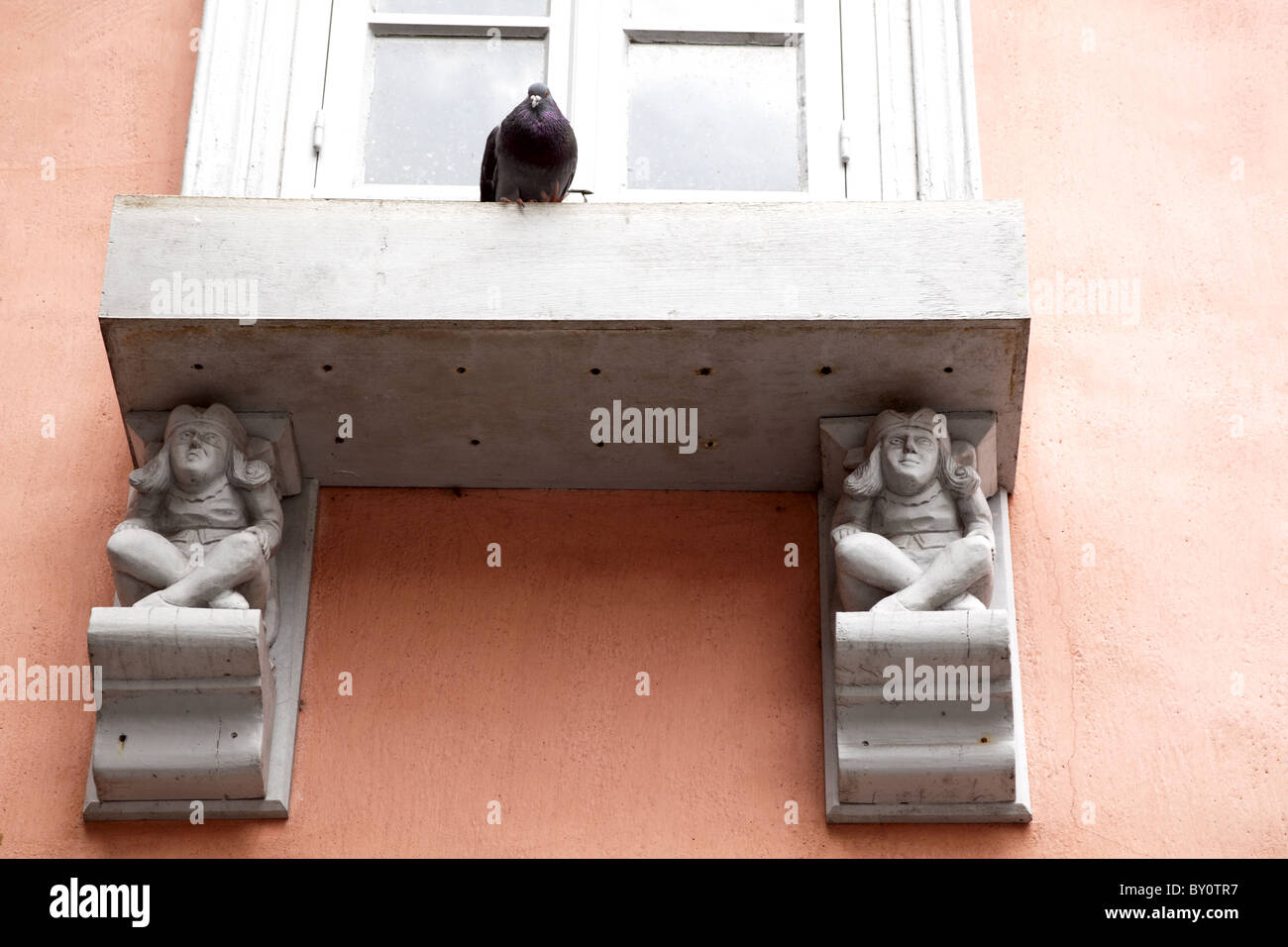 Carved wooden figures supporting window ledge in the town of Quimper ...