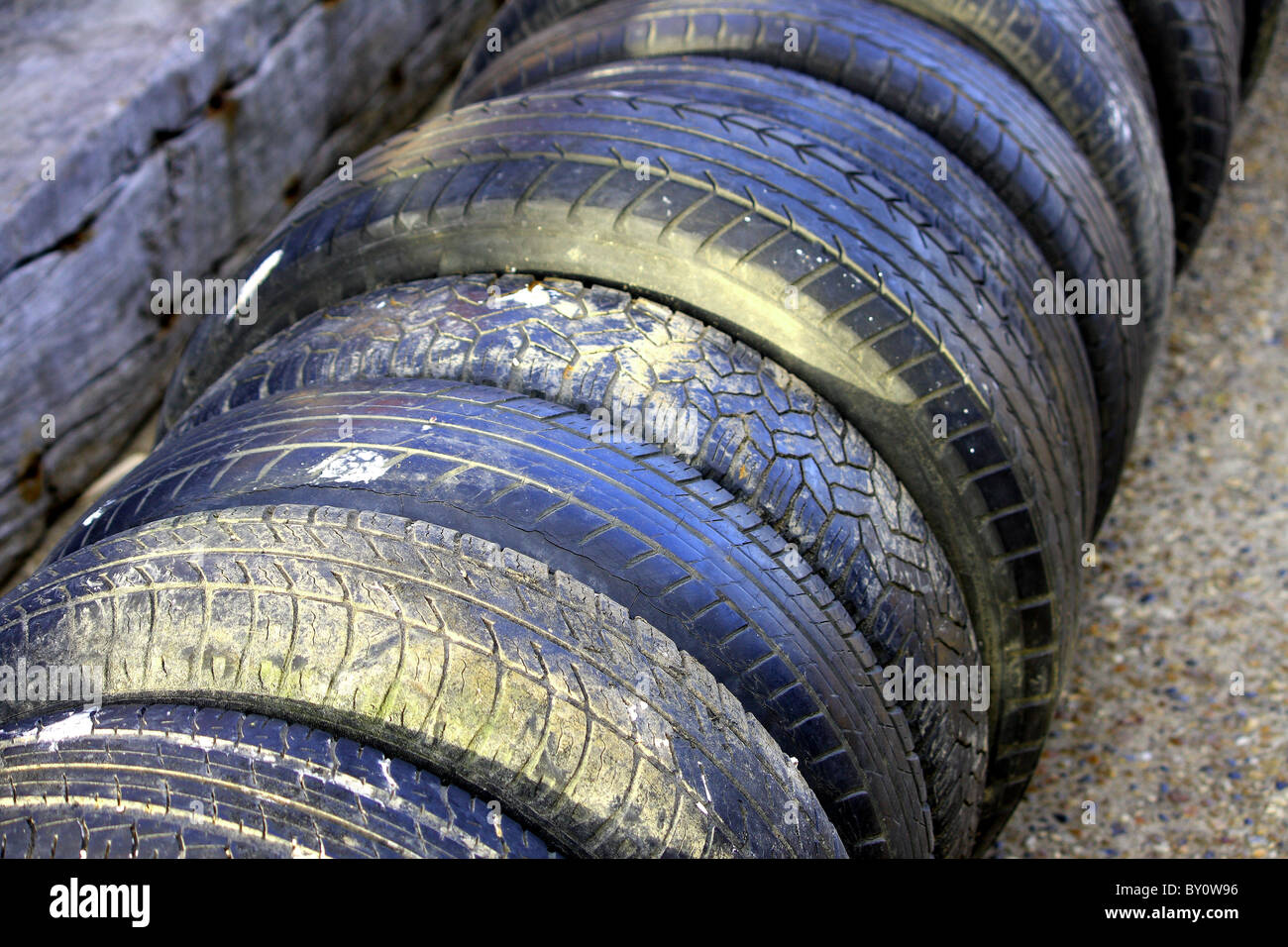 A group of old used tyres dumped by the roadside Stock Photo - Alamy