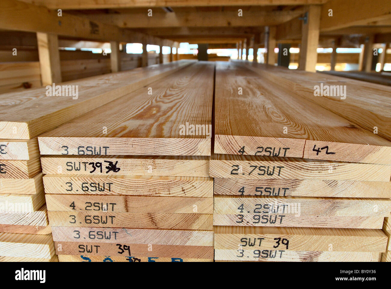 Stacked wood in timber's merchant warehouse Stock Photo - Alamy