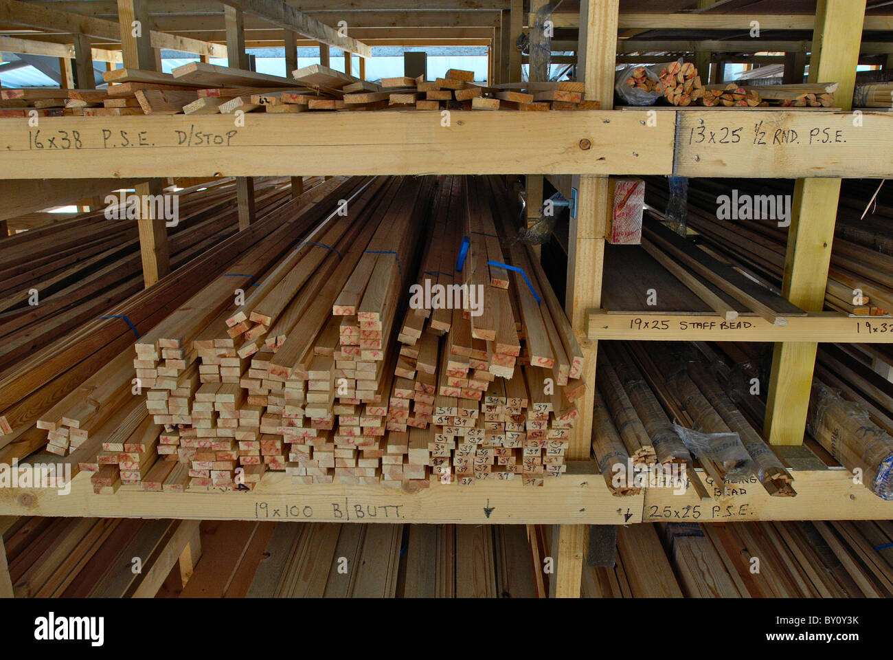 Stacked wood in timber's merchant warehouse Stock Photo - Alamy