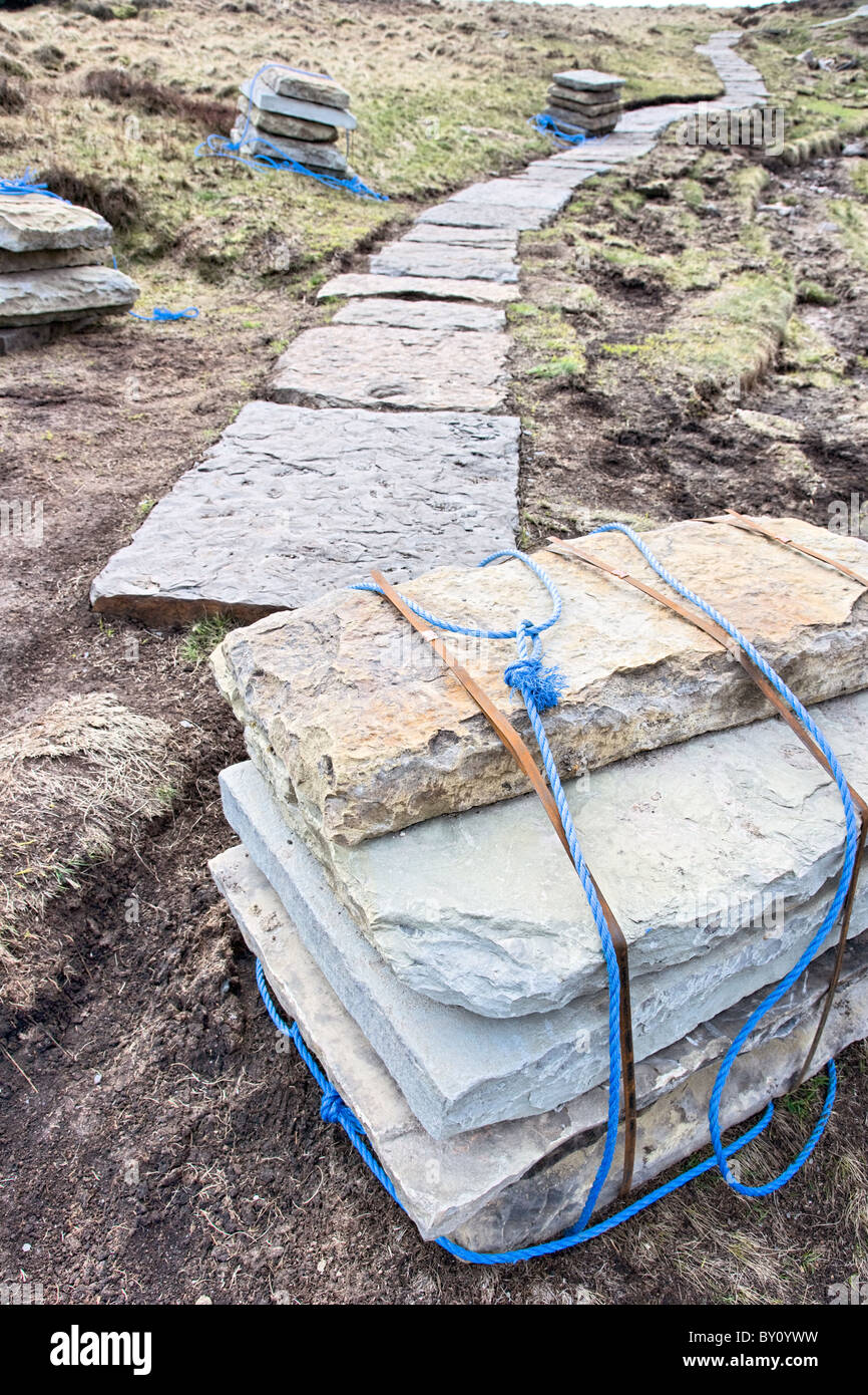 Slate block stone path being laid over peat moor to reduce erosion on ...