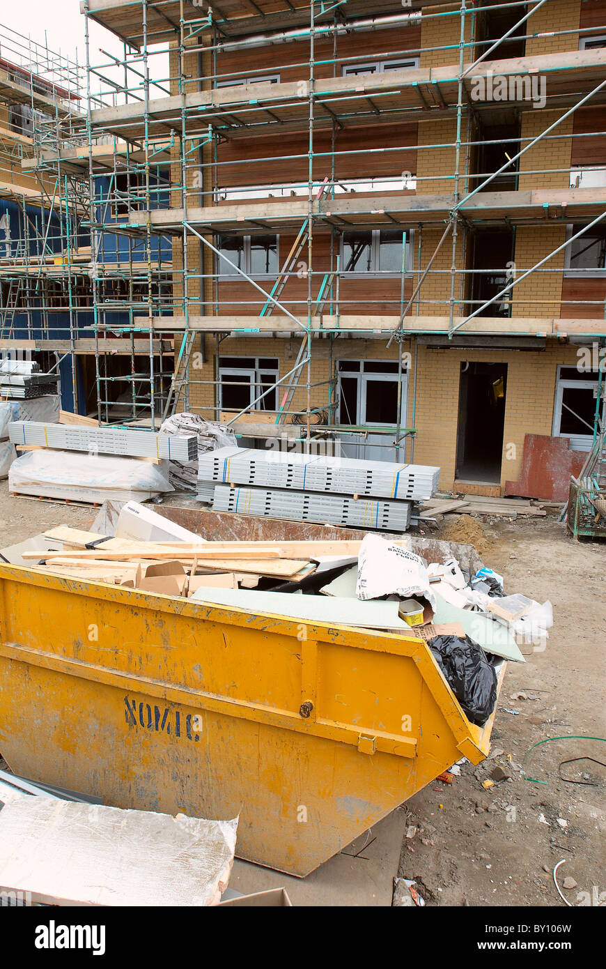Overloaded skip on a building site - waste segregation Stock Photo - Alamy
