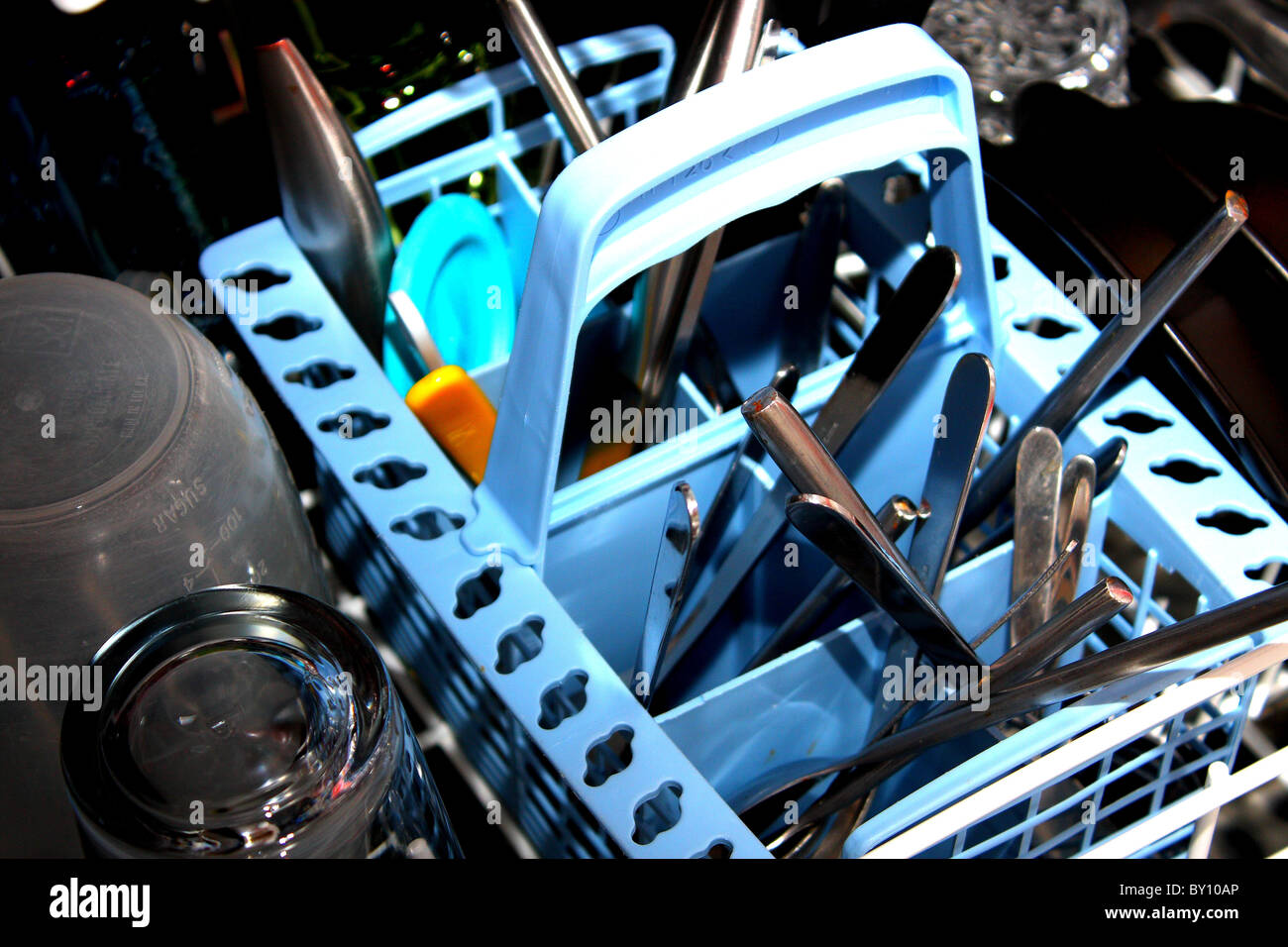 The utensils cutlery tray in a dishwasher; having just finished its ...