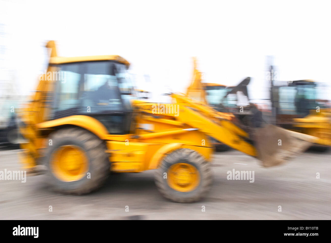 Front loader side view (blurred motion Stock Photo - Alamy