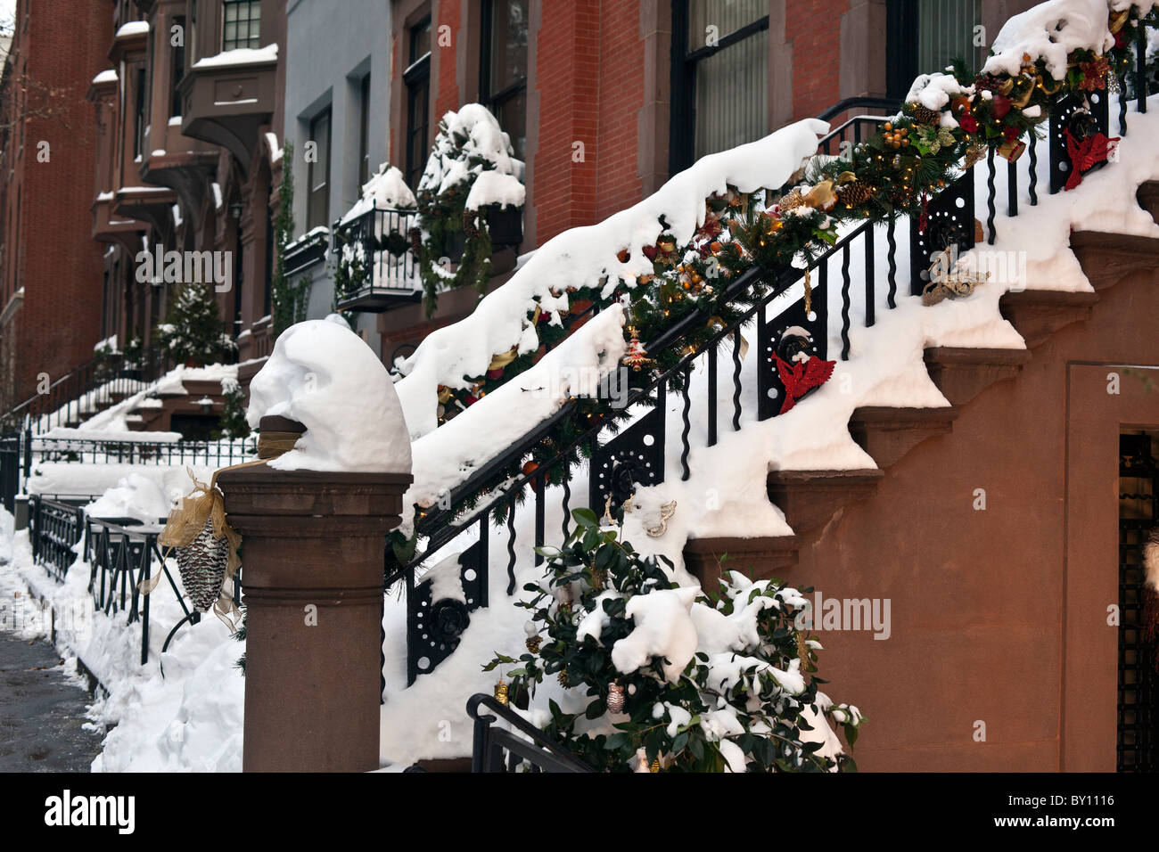Decorated brownstone stoop covered with snow in winter Stock Photo - Alamy