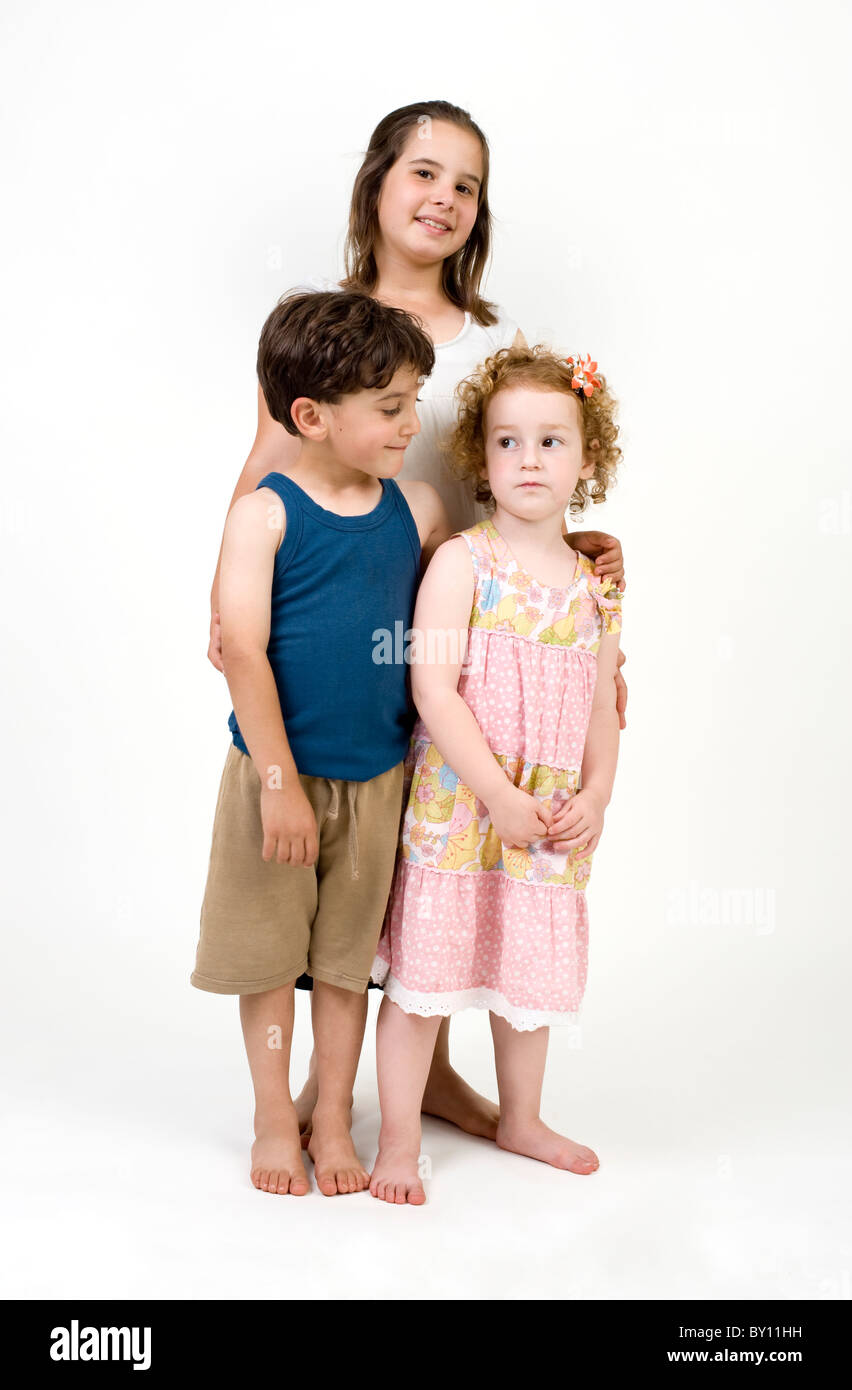 three kids posing to camera isolated on white Stock Photo - Alamy