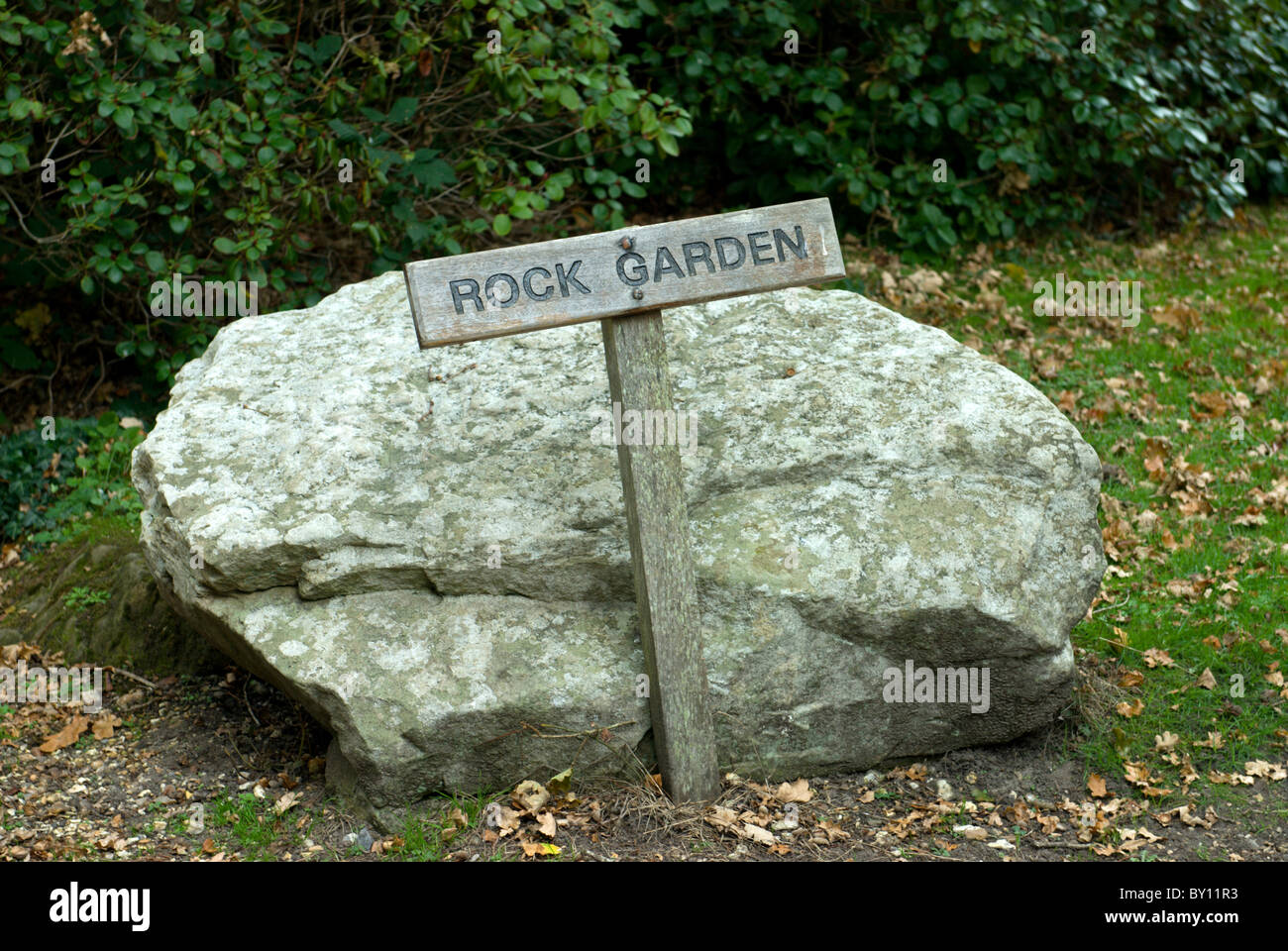 An amusing sign for a rock garden, leaning against a giant rock but ...