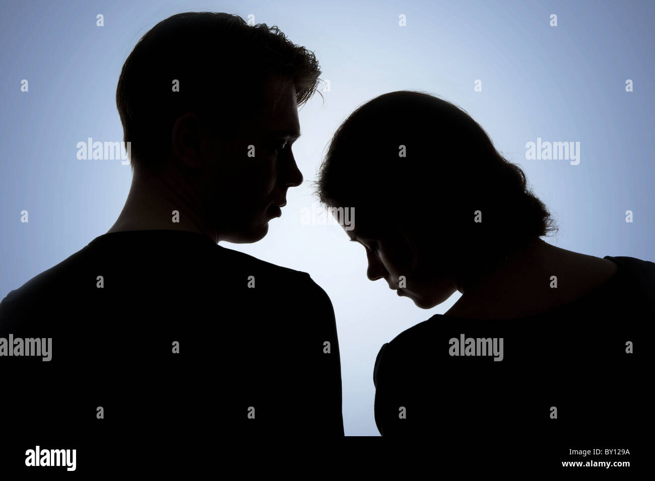 Two heads of amorous people close to each other on blue background ...