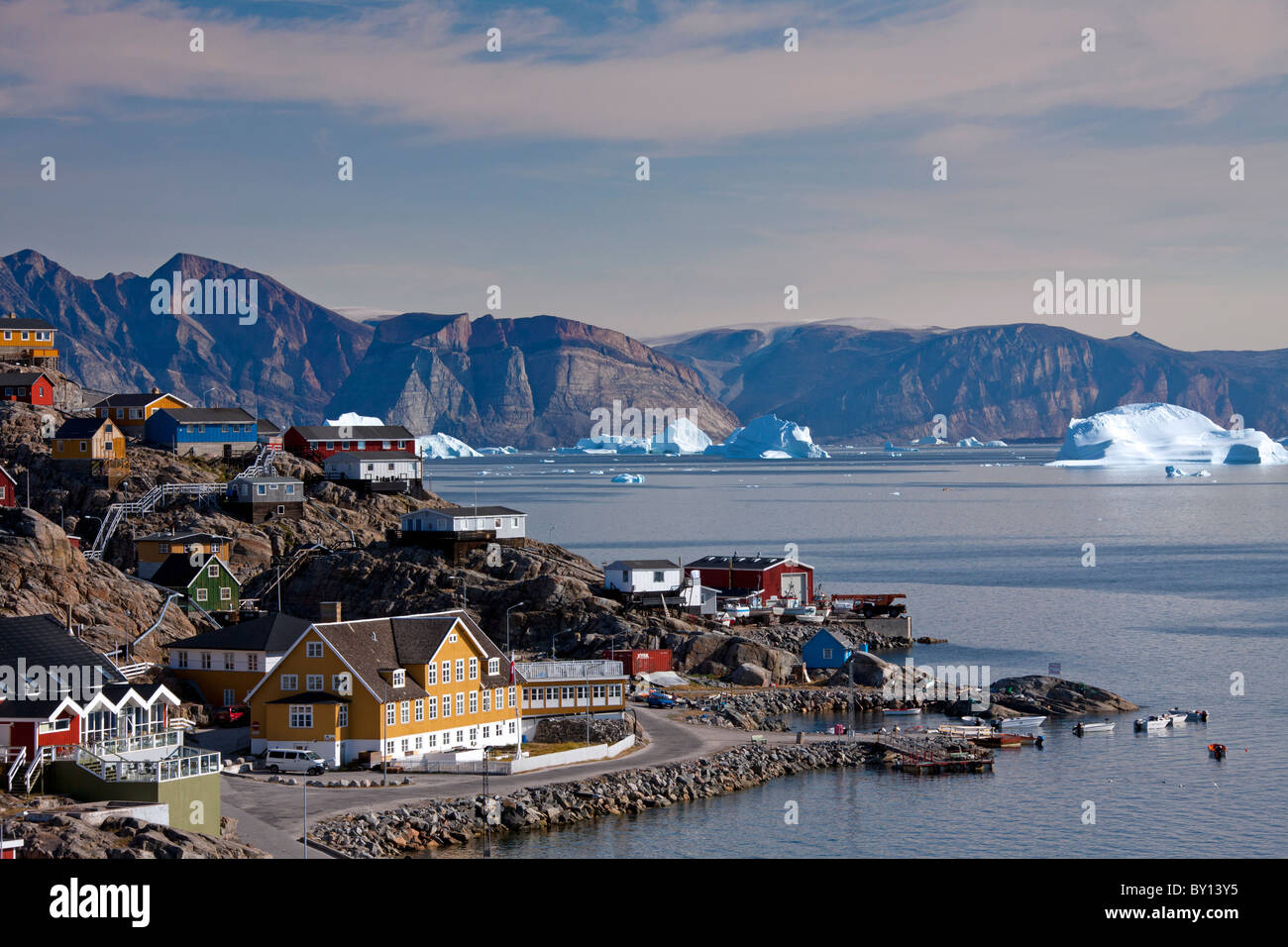 Uummannaq village with colourful houses and icebergs in the fjord ...