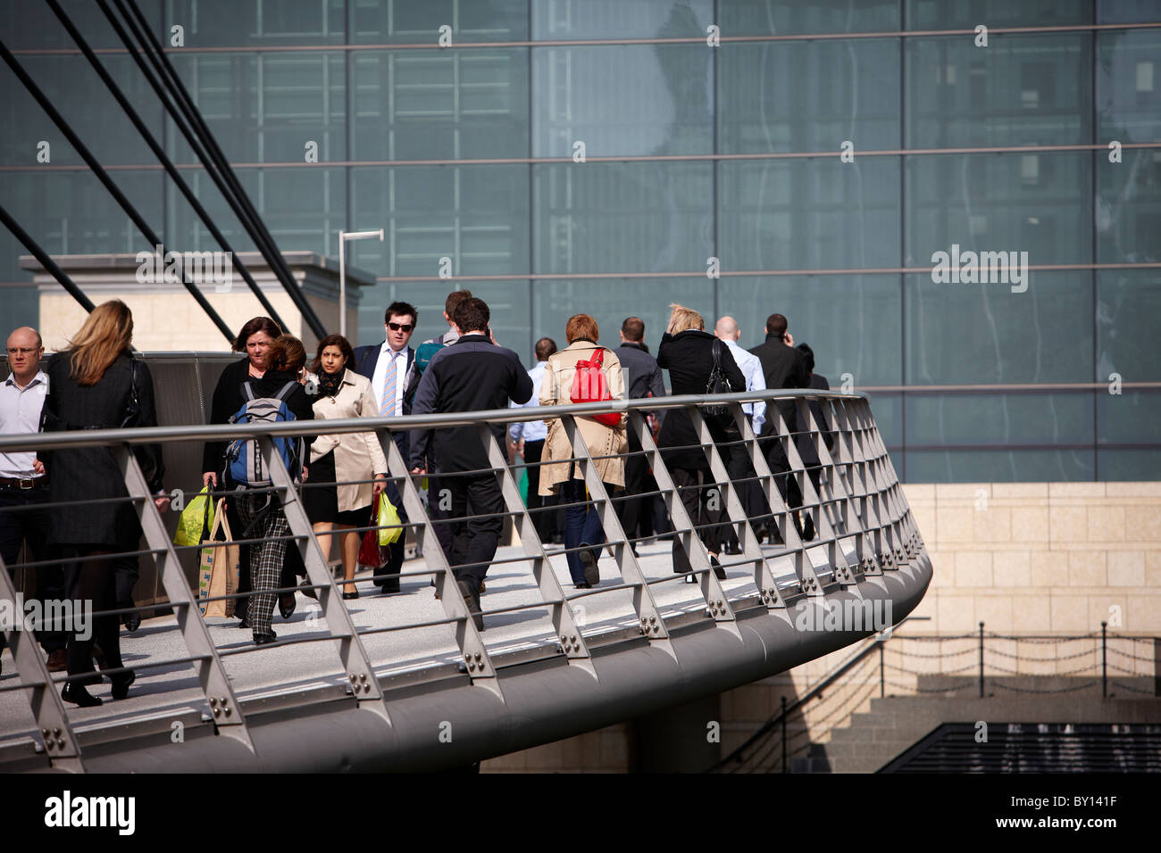 Pedestrians using a footbridge at Canary Wharf, Docklands, London Stock ...